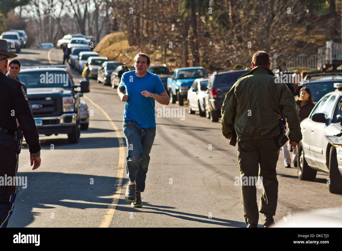 Newtown, Connecticut, USA. 14th Dec, 2012. ROBBIE PARKER runs to Sandy ...