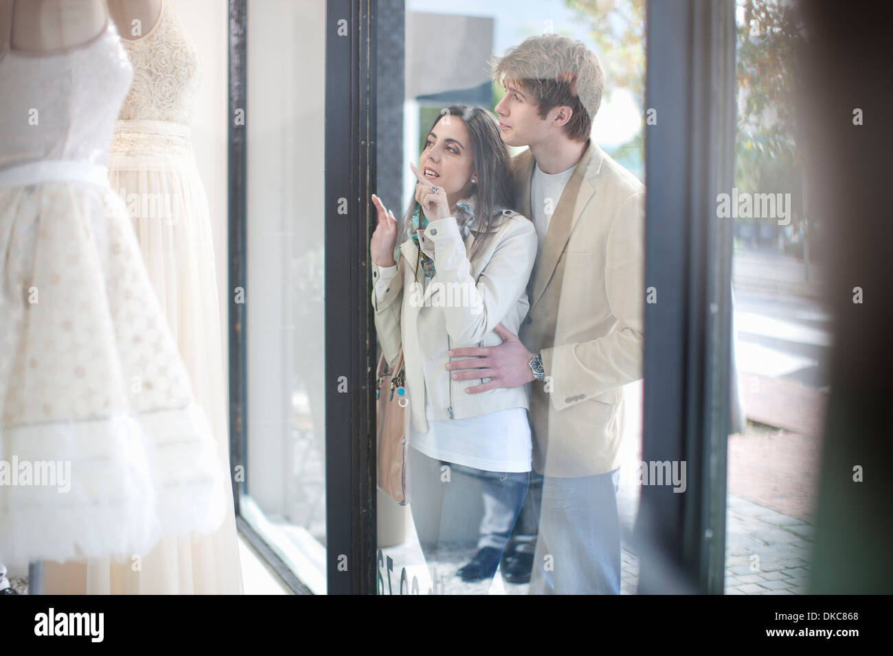 Young couple window shopping, looking through shop front Stock Photo ...