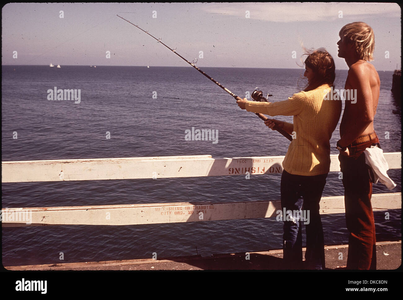 A fisherman casts a line off a pier, a common activity for recreation ...