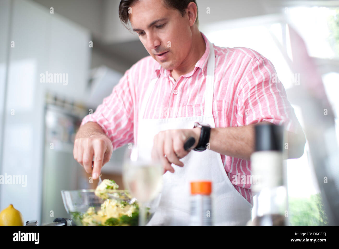 Mature men cooking, mixing ingredients in bowl Stock Photo - Alamy