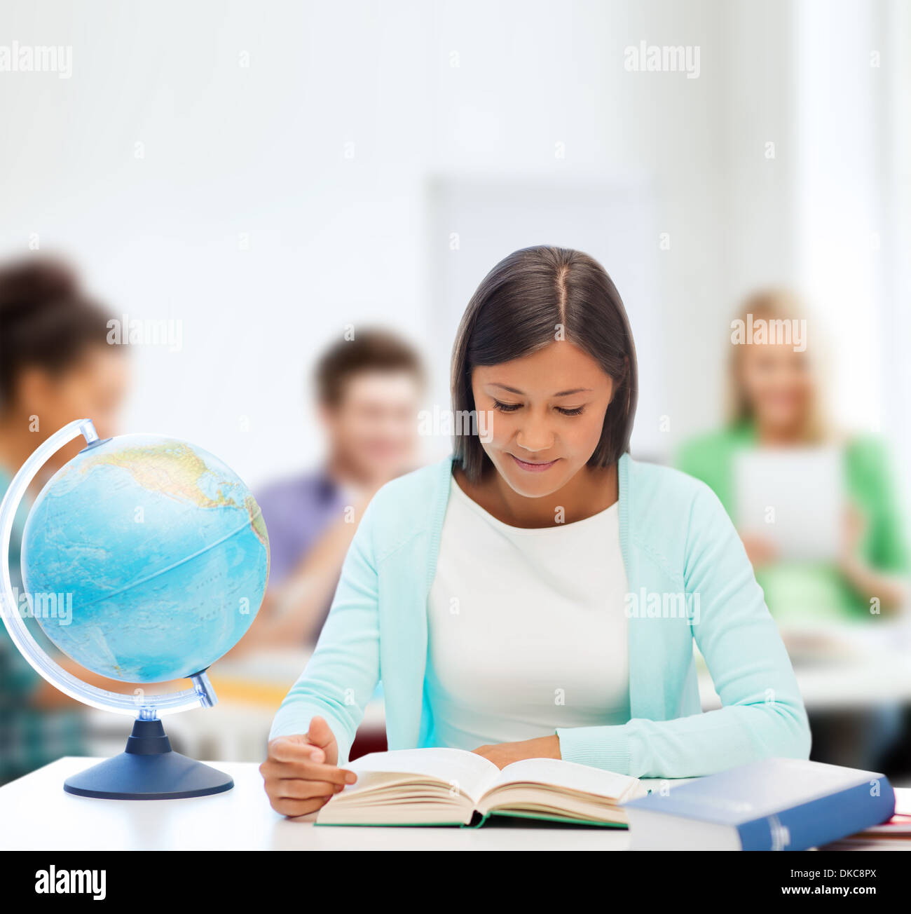 teacher with globe and book at school Stock Photo - Alamy