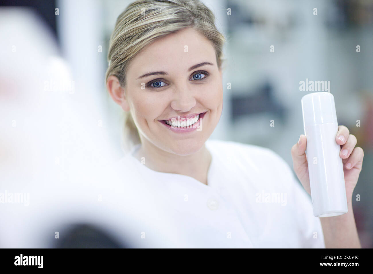 Shop assistant showing make up Stock Photo - Alamy