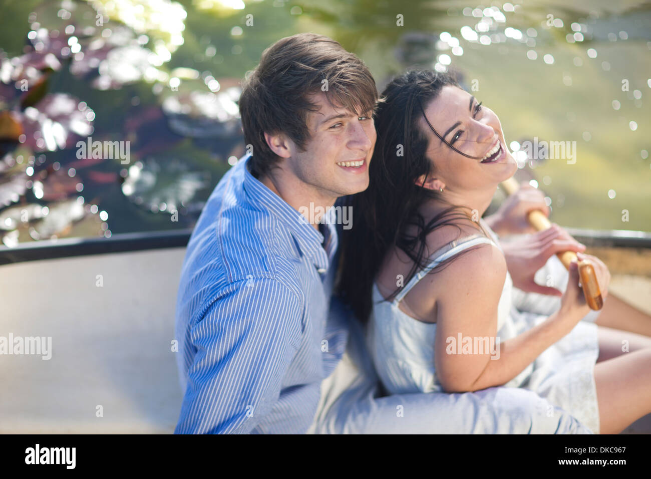 Young couple laughing in rowing boat Stock Photo - Alamy