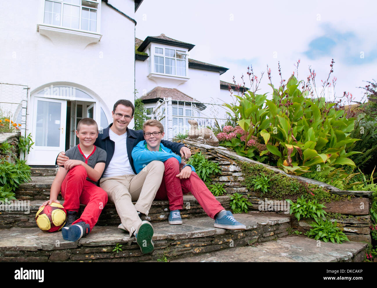 Boy in red shirt sitting hi-res stock photography and images - Alamy