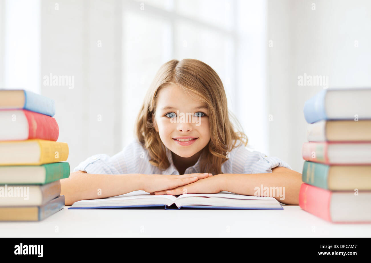 smiling little student girl with many books Stock Photo - Alamy