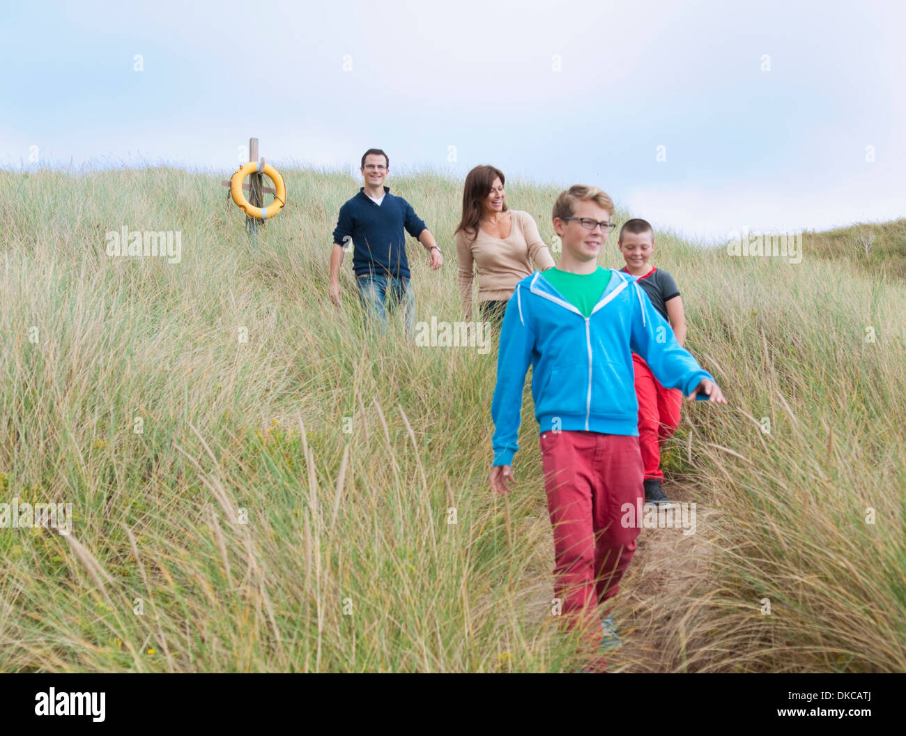 Family strolling coastal path Stock Photo - Alamy