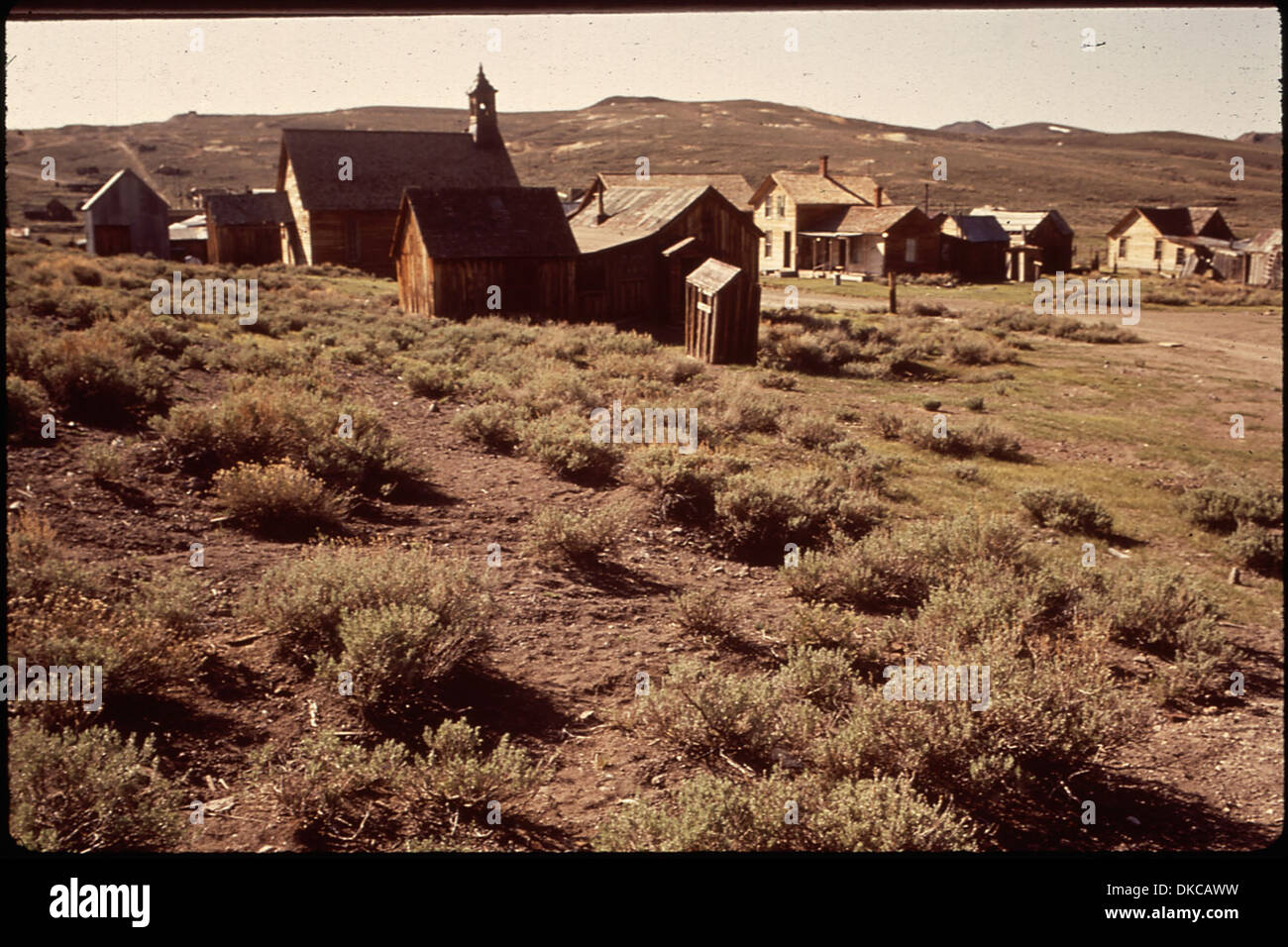 The photograph depicts a ghost town, a once-inhabited area now ...