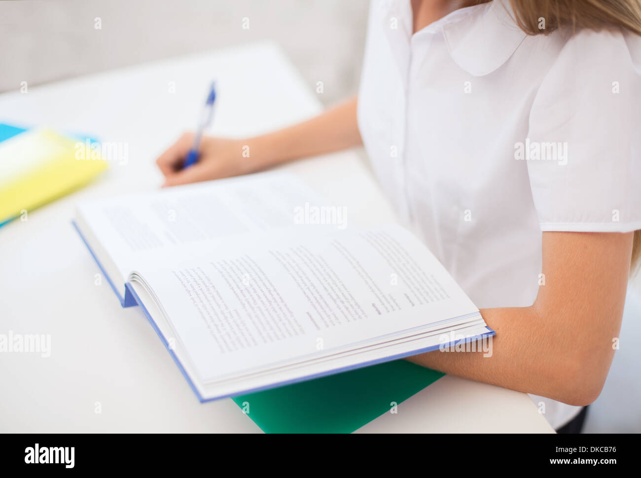 student girl writing in notebook at school Stock Photo - Alamy