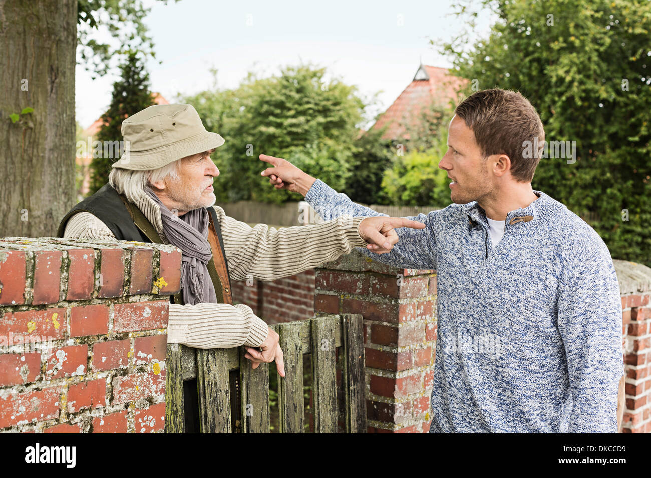 Senior man and mid adult man arguing Stock Photo - Alamy