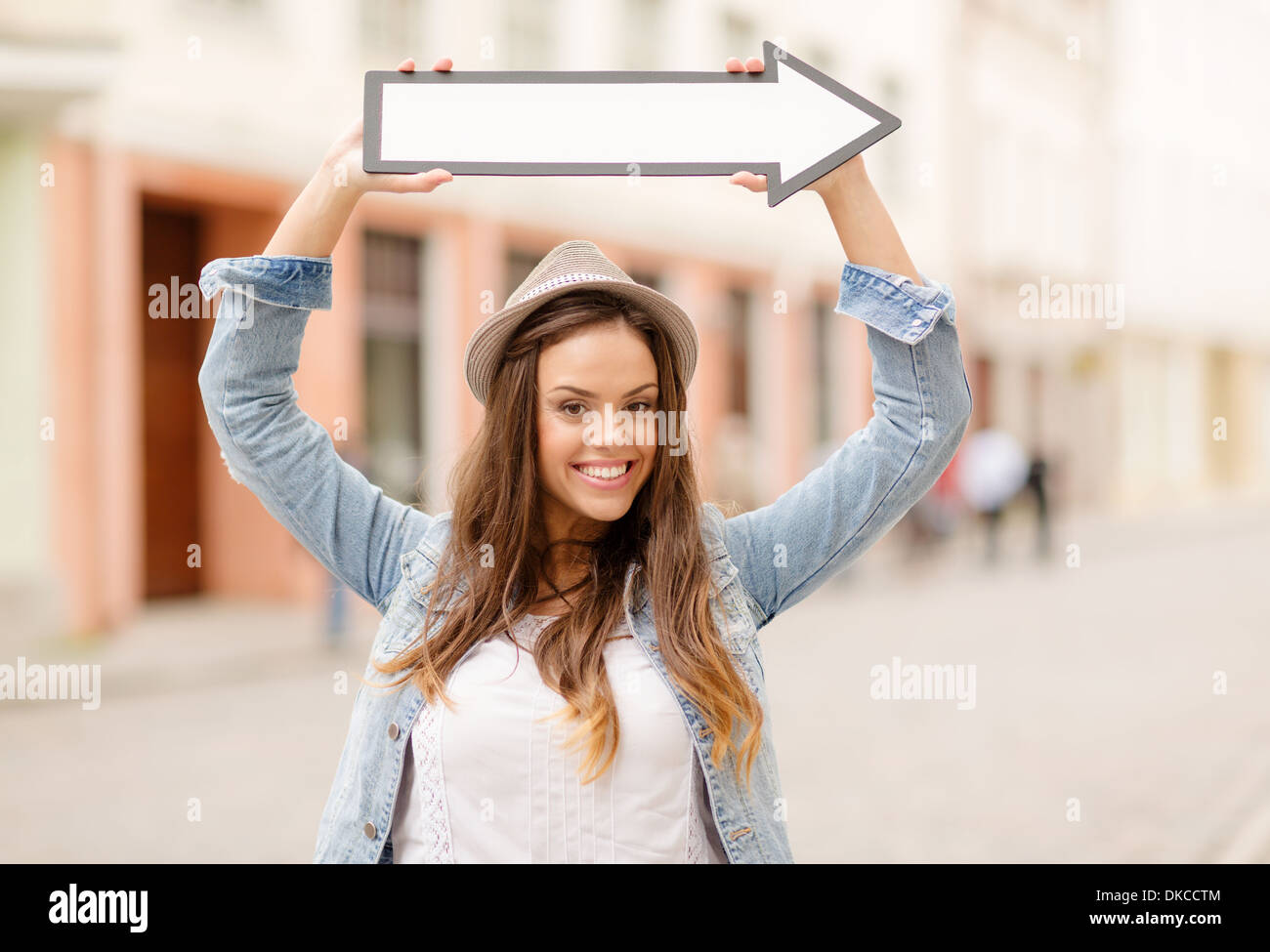Girl showing direction arrow in hi-res stock photography and images - Alamy