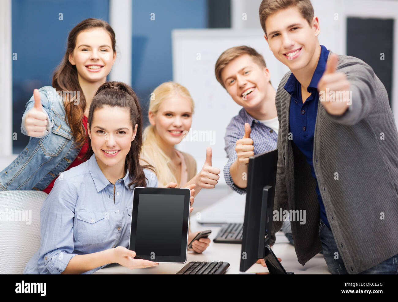 students with monitor and blank tablet pc screen Stock Photo - Alamy