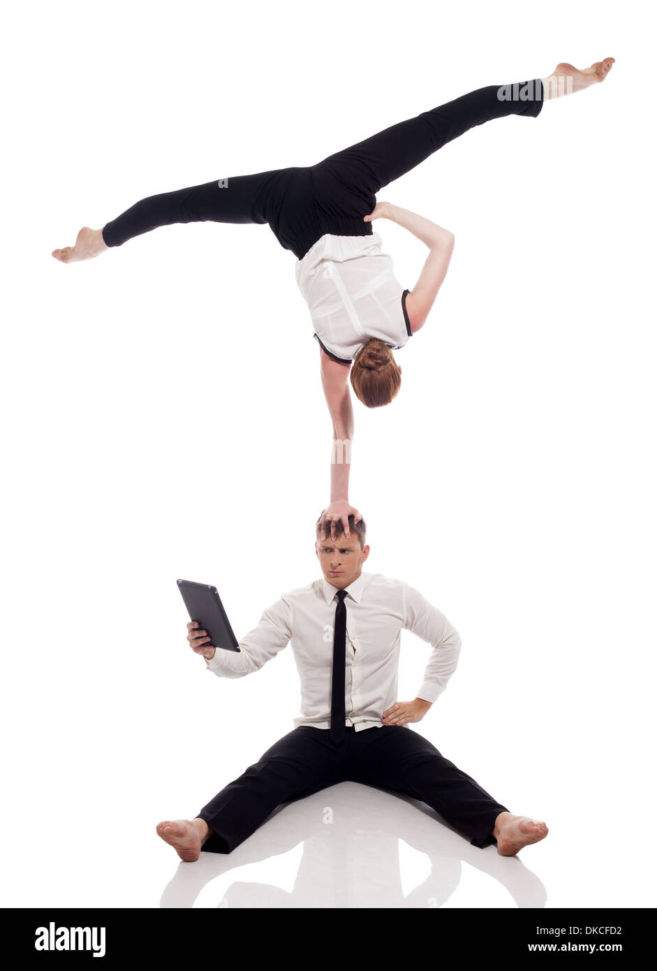 Businessmen-acrobats posing with laptop in studio Stock Photo - Alamy