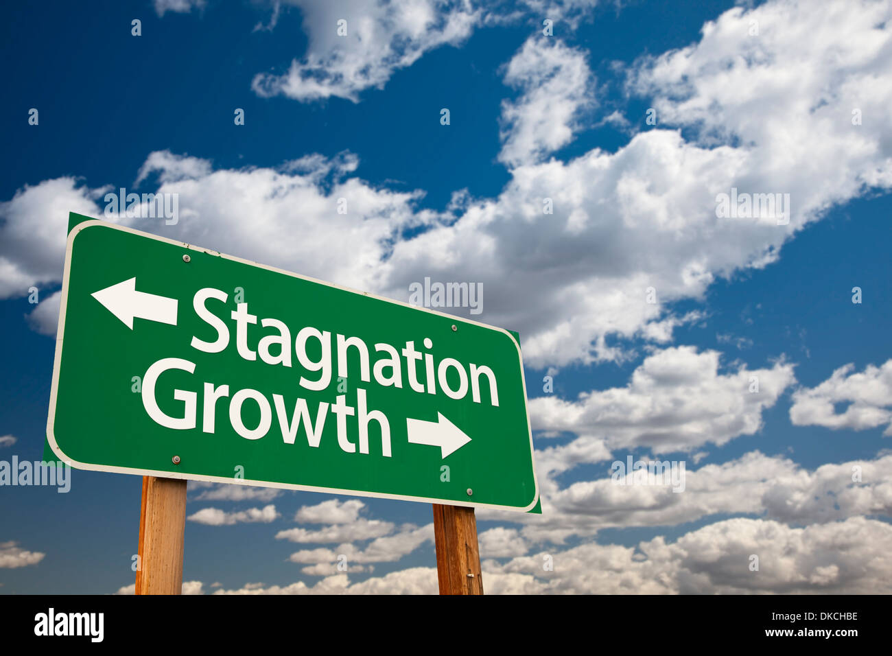 Stagnation or Growth Green Road Sign Over Dramatic Clouds and Sky Stock ...