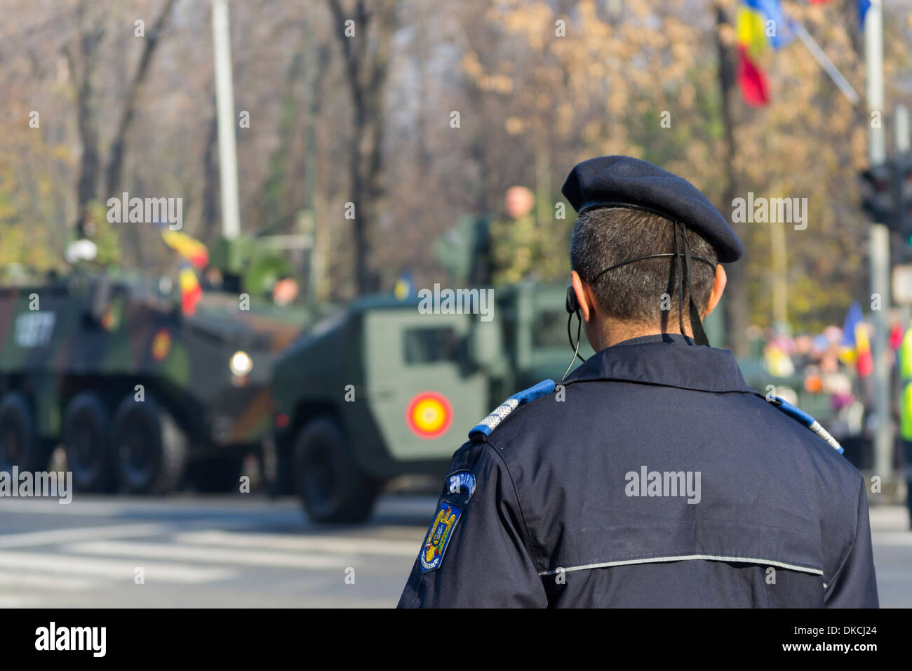 Romanian Gendarmerie officer watching over military vehicles - December ...