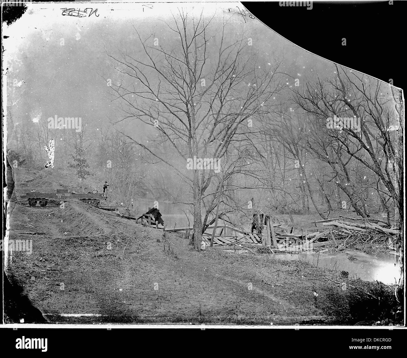 The image shows the ruins of a bridge, likely from a bygone era. The ...
