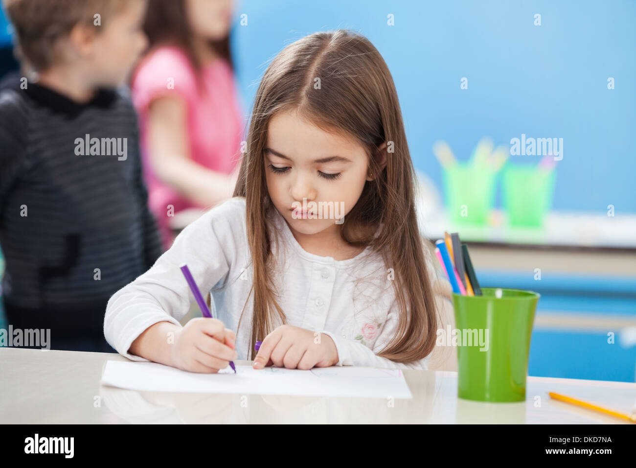 Cute Girl Drawing With Sketch Pen In Classroom Stock Photo - Alamy