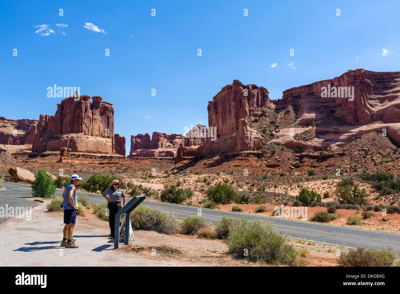 Tourists talking to a park ranger at Courthouse Towers viewpoint ...