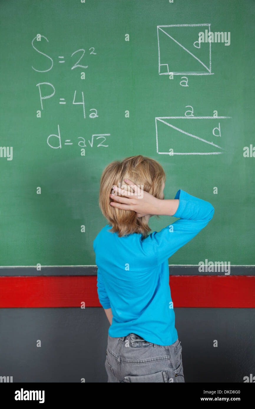 Confused Little Boy Looking At Board Stock Photo - Alamy