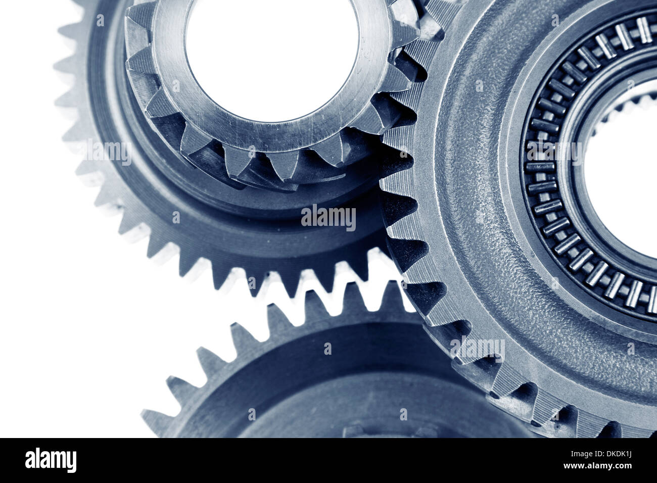 Metal cog gears joining together Stock Photo - Alamy