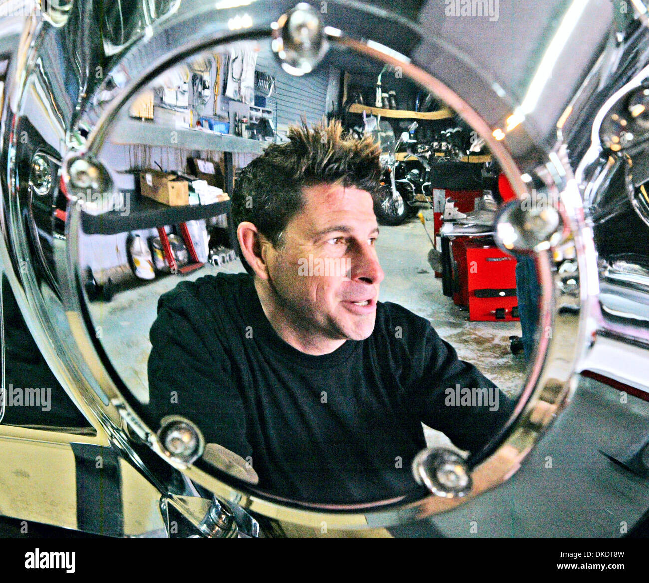 The reflection of Marcus Melendez in the motor of a Harley Davidson at ...