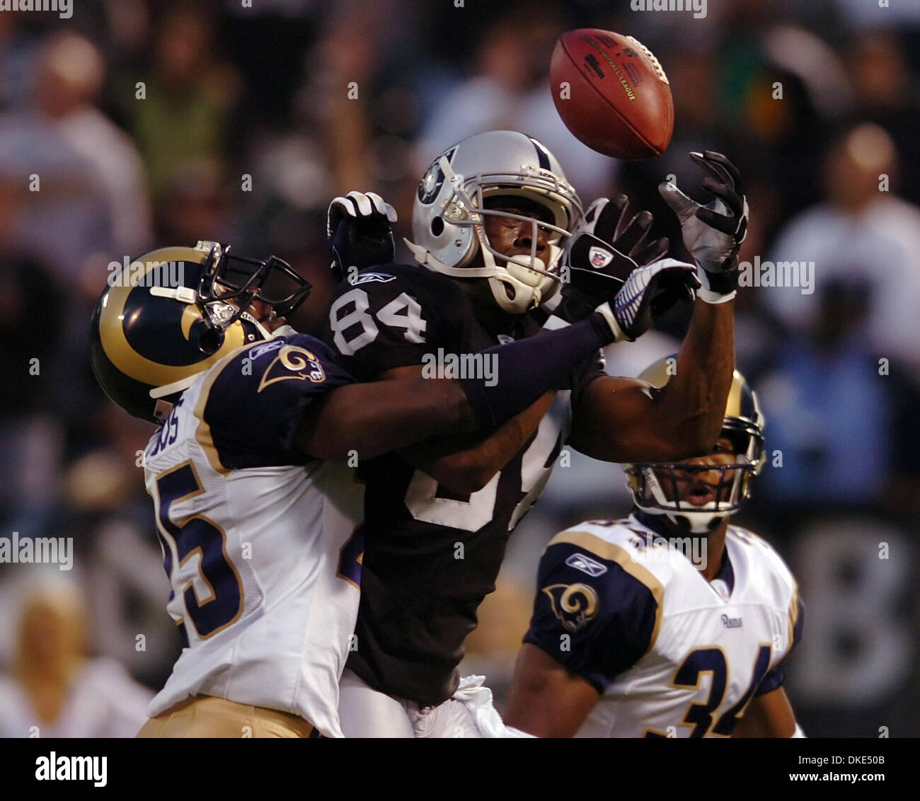 Oakland Raiders Jerry Porter, #84, bobbles a pass while being guarded ...