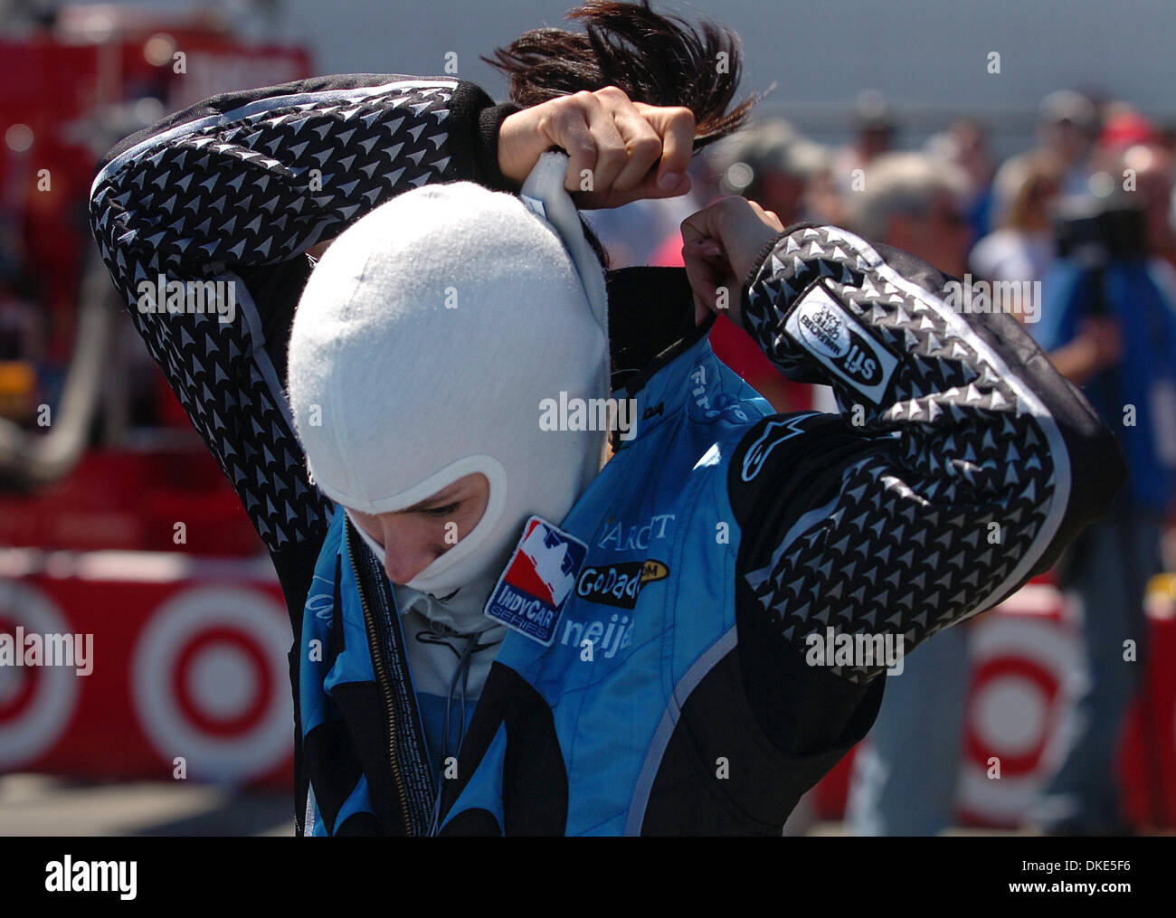 Indy driver Danica Patrick, #7, tucks her hair into her suit as she ...