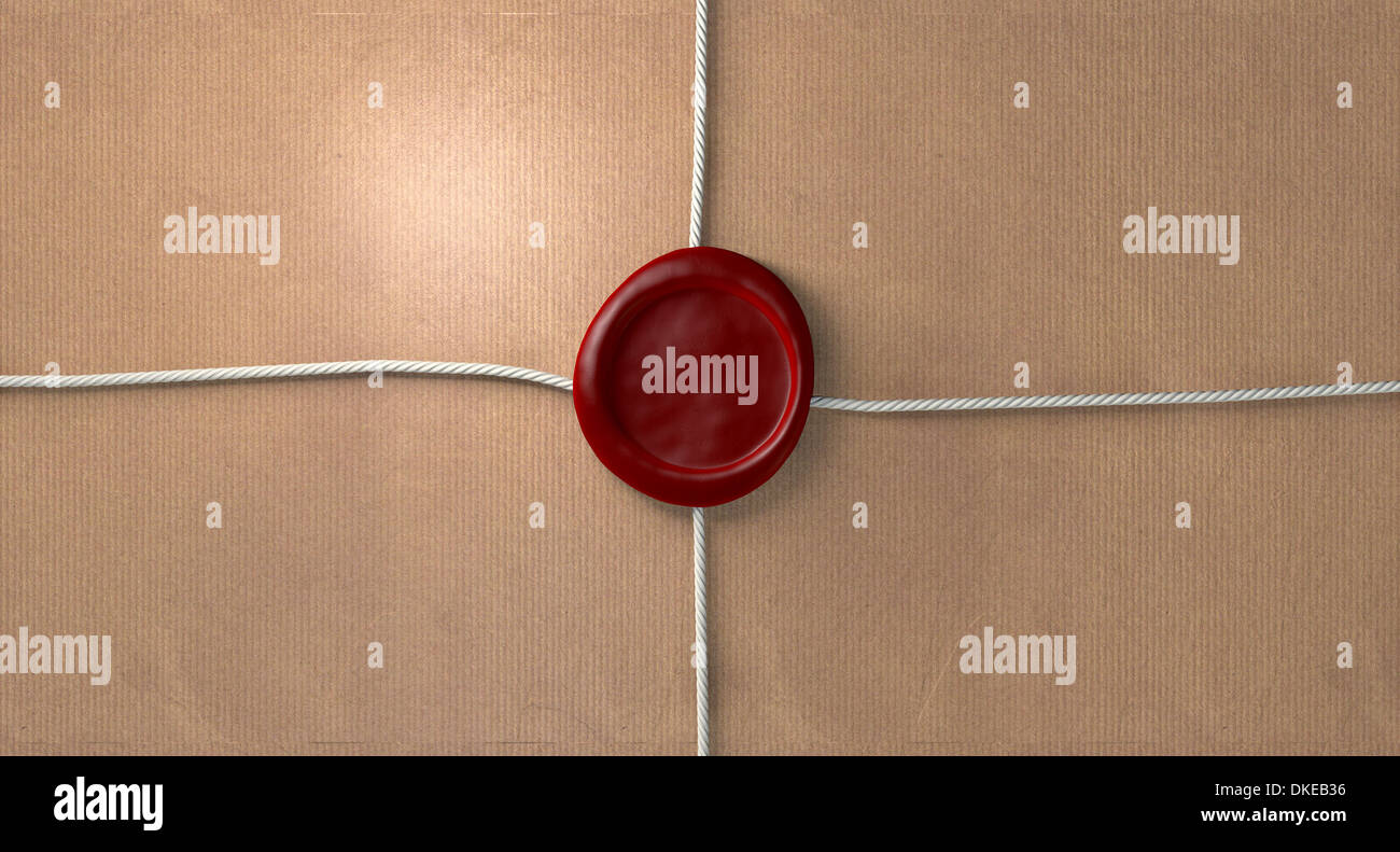 A closeup of a parcel wrapped in brown paper bound by a thin string and ...