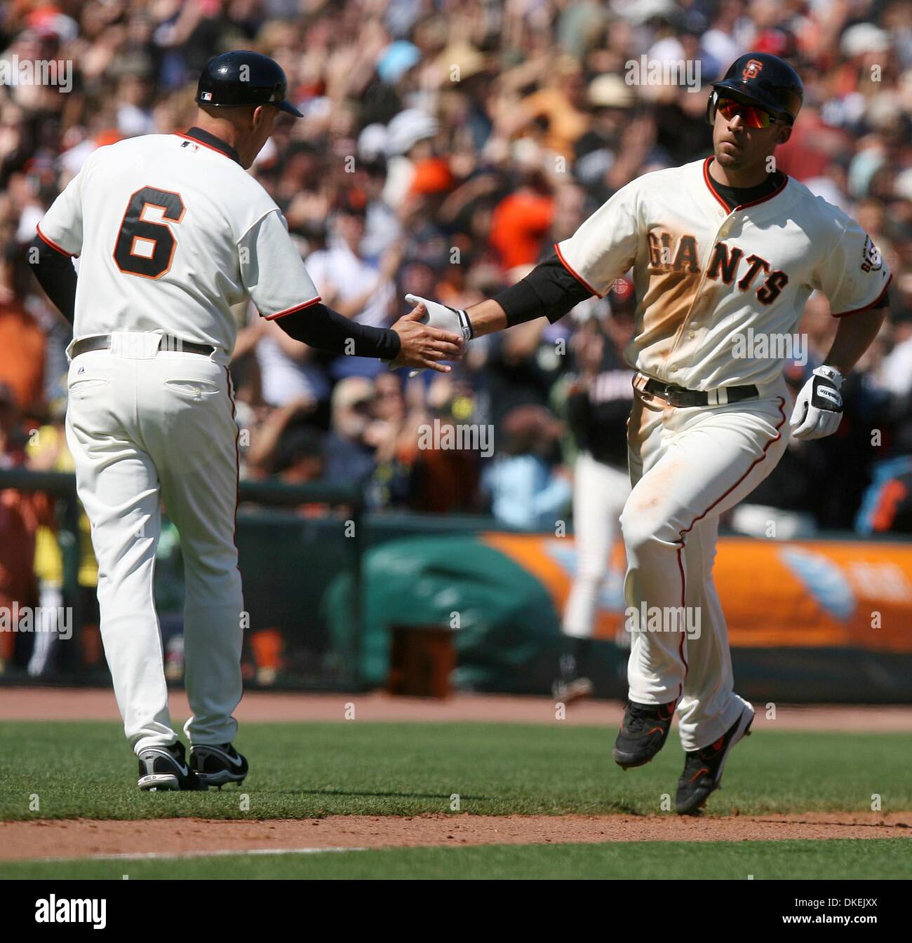 Travis Ishikawa is congratulated by third base coach Tim Flannery after ...