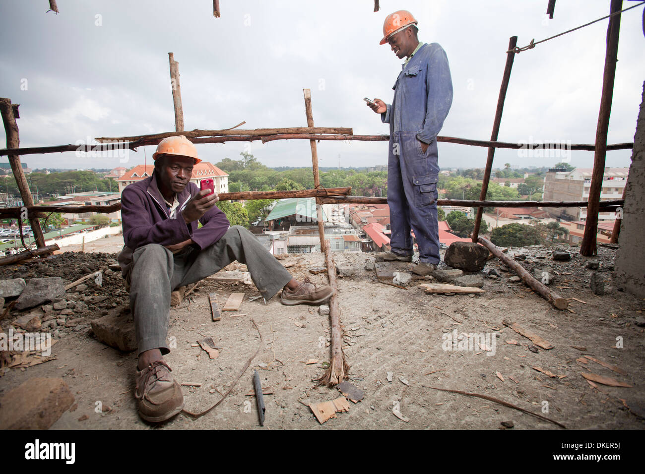 Workmen using mobile phones on construction site, Nairobi, Kenya Stock ...
