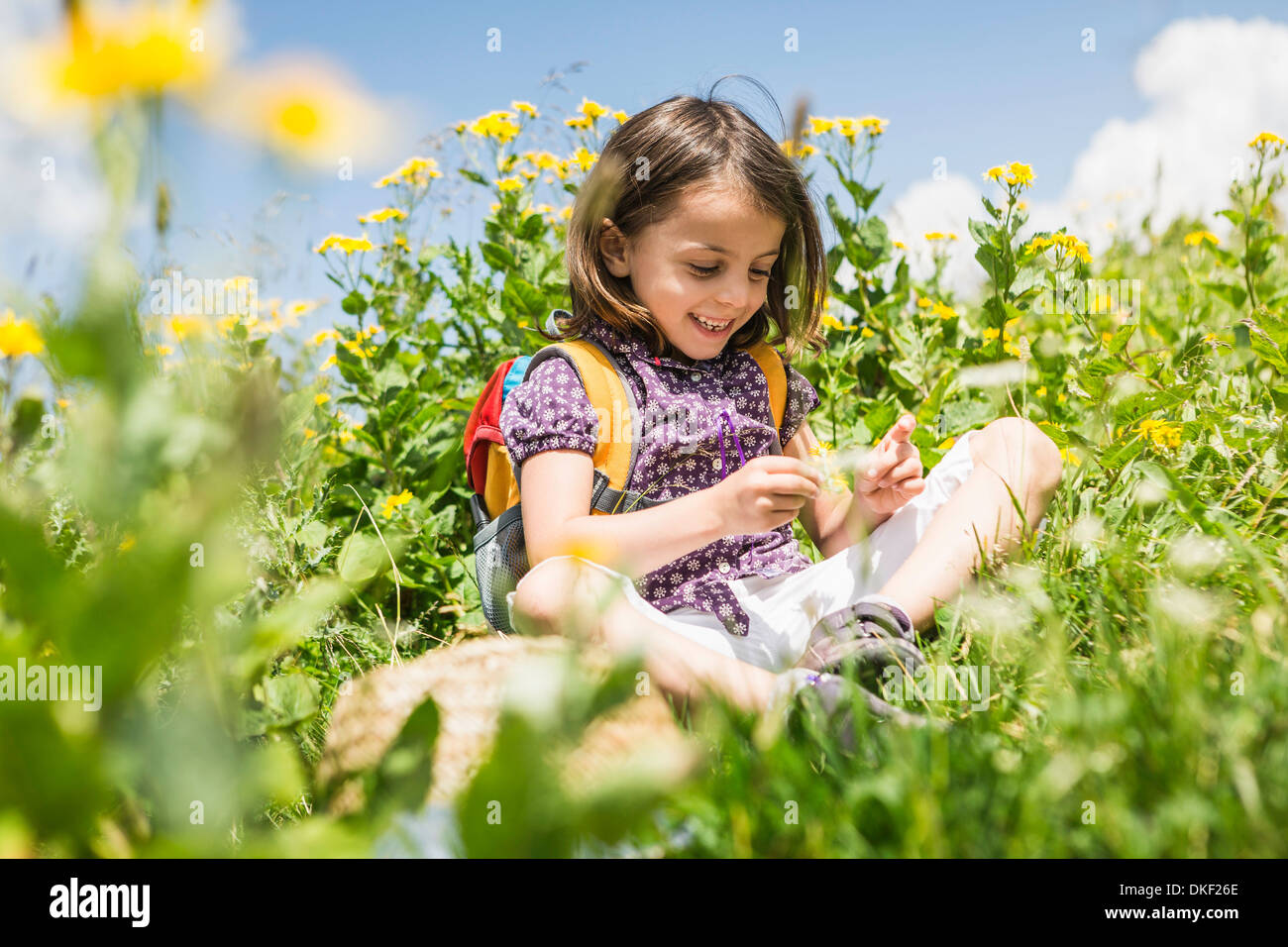 Girl sitting alone in field hi-res stock photography and images - Alamy