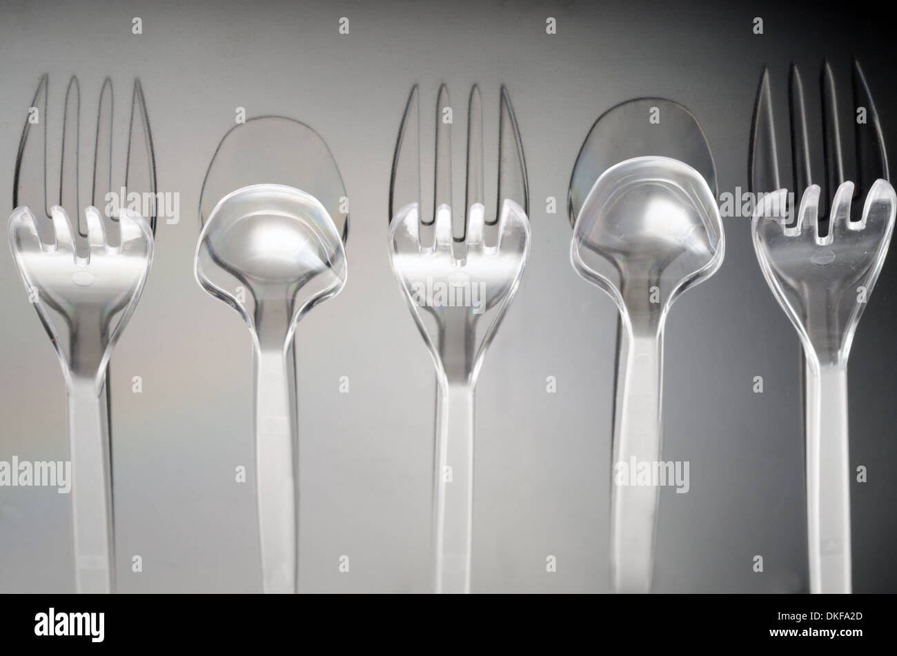 two spoon and three forks transparent plastic Stock Photo - Alamy