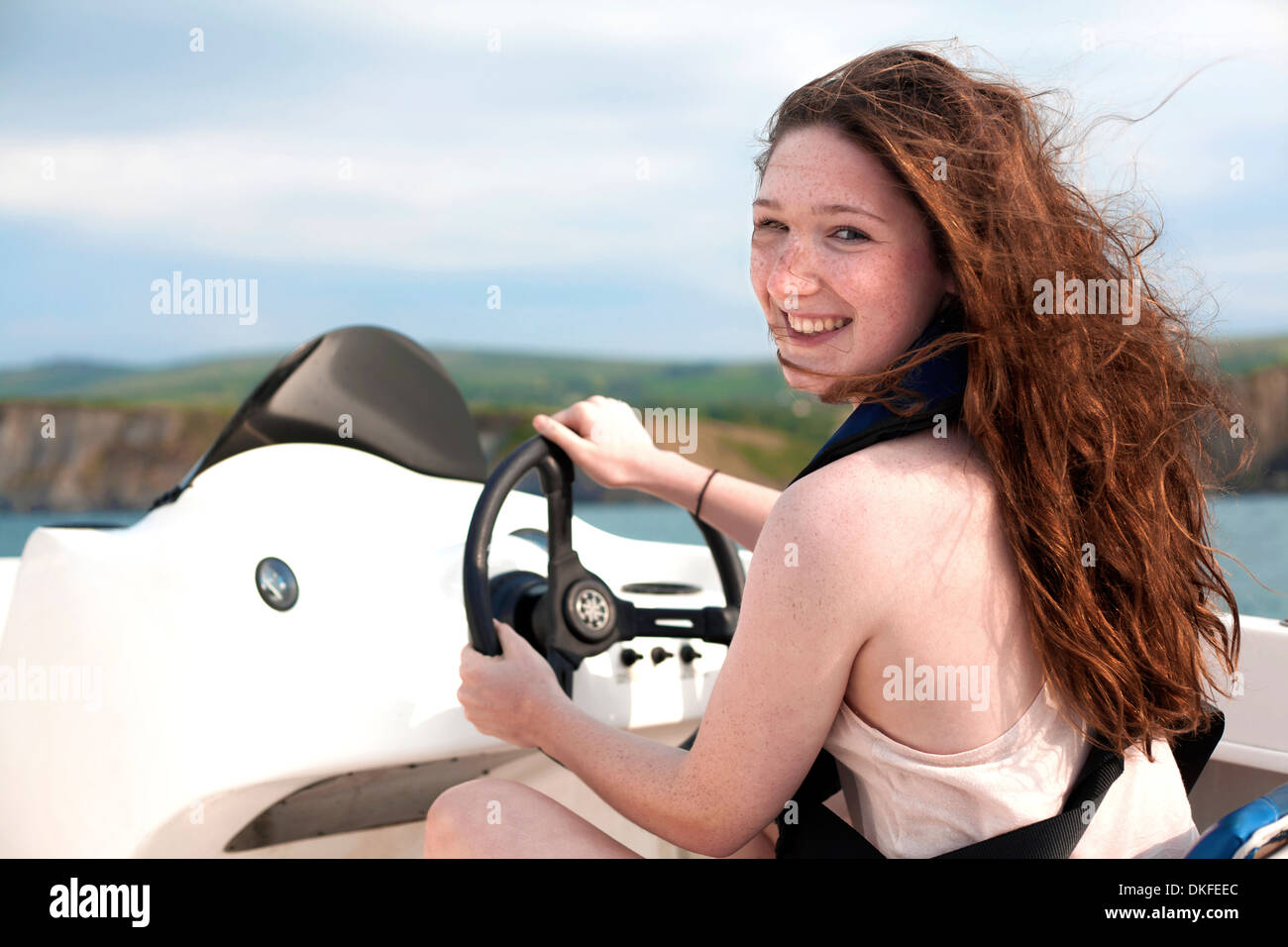 Teenager driving speedboat Stock Photo - Alamy