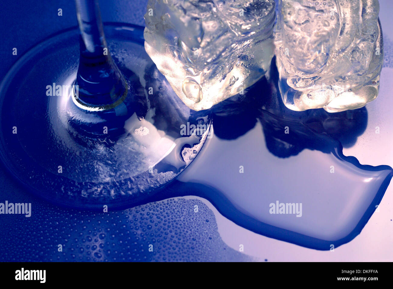 Melting ice cubes beside the stem of a glass Stock Photo - Alamy