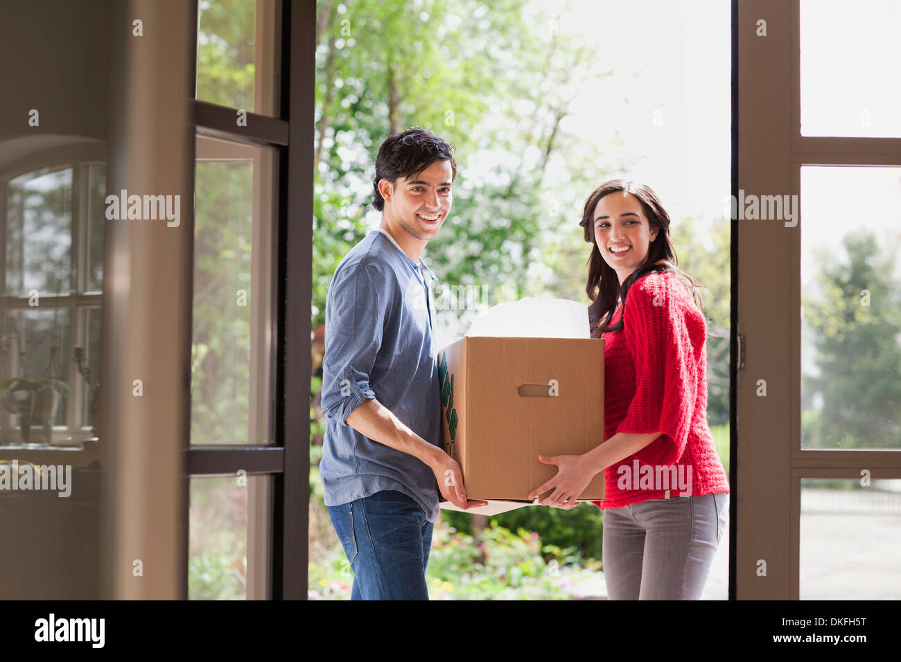 Young black woman carrying box hi-res stock photography and images - Alamy