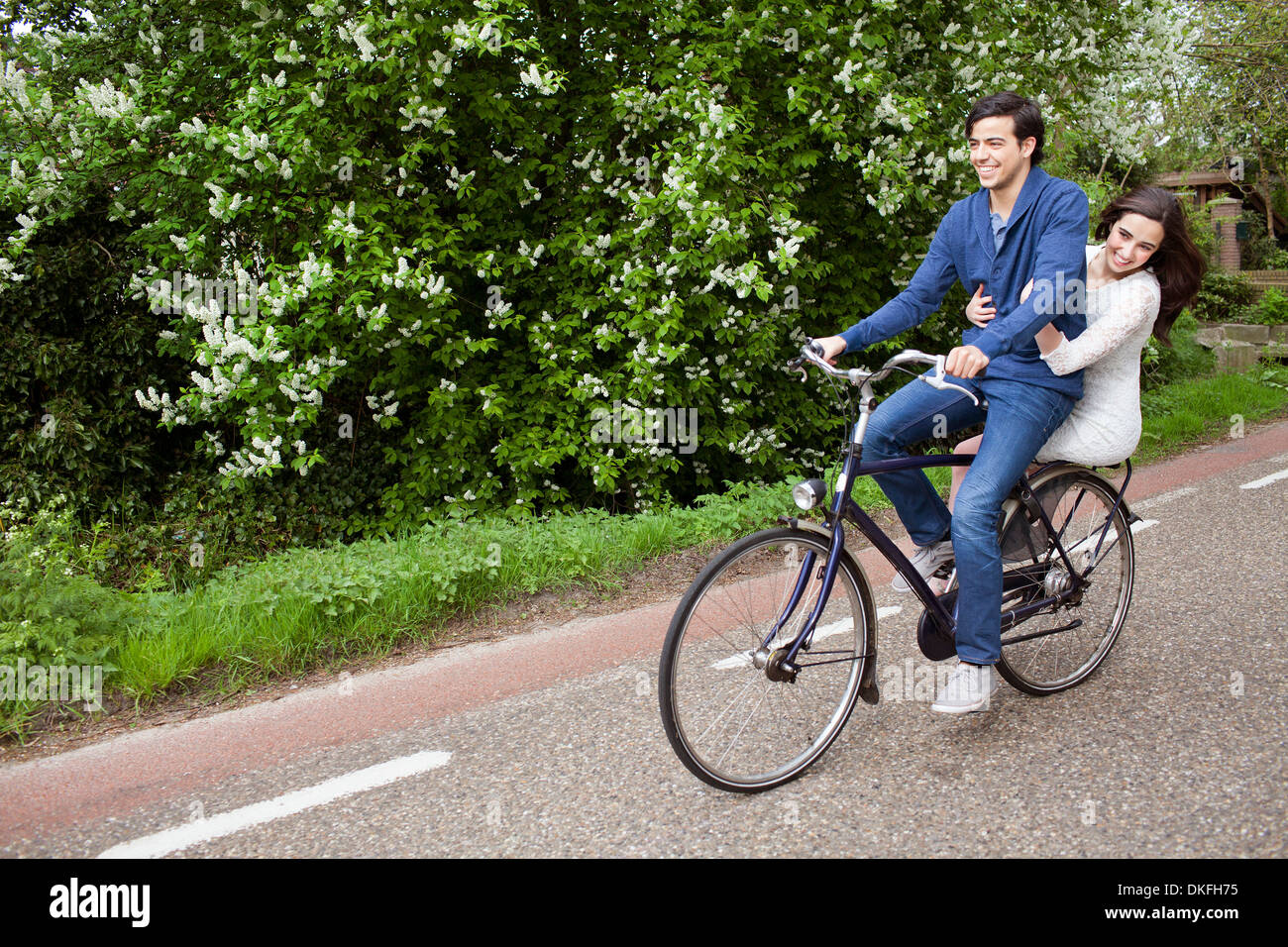 Young couple enjoying cycle ride Stock Photo - Alamy
