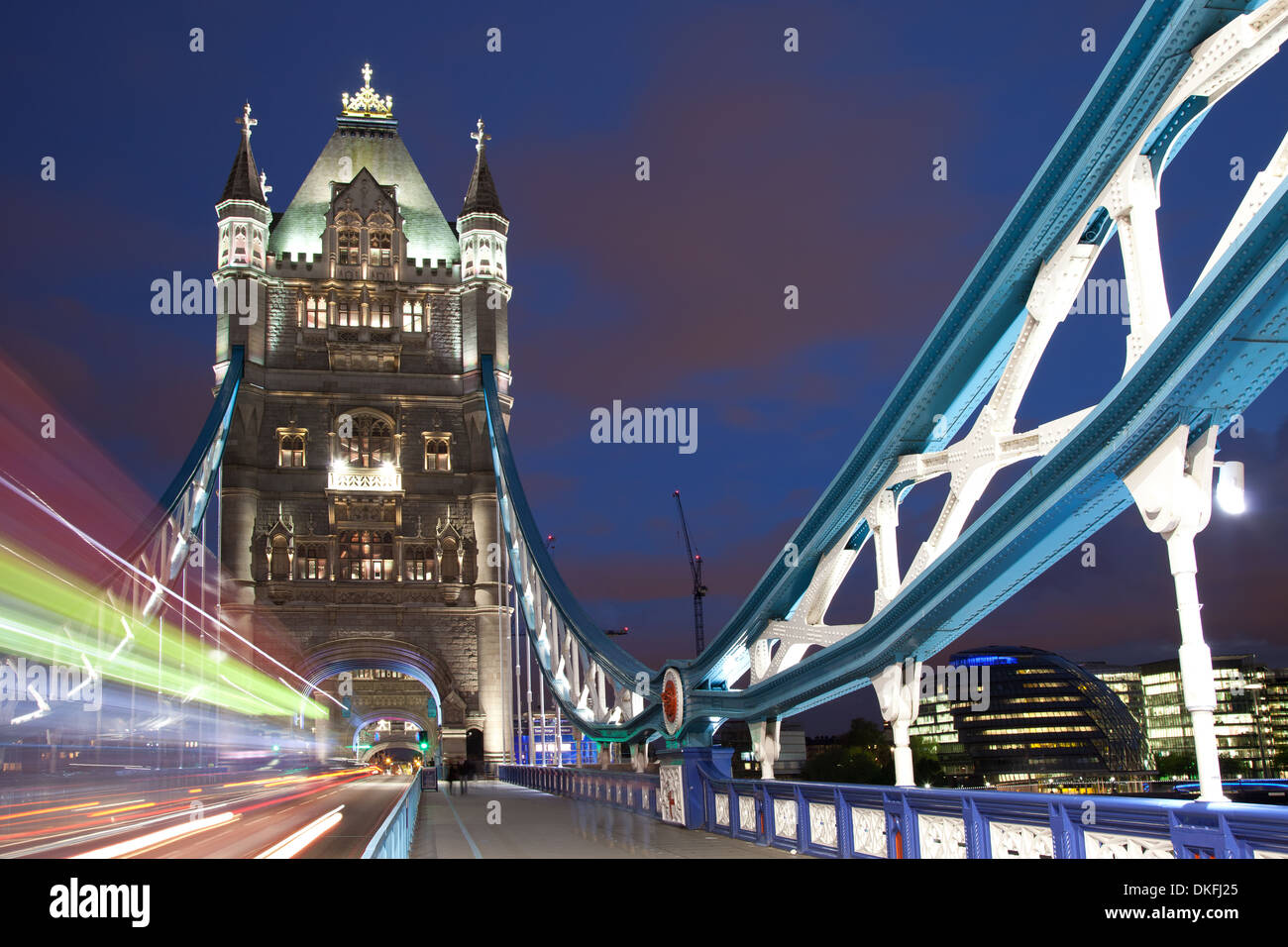 London Tower Bridge at night with a bus passing by Stock Photo - Alamy