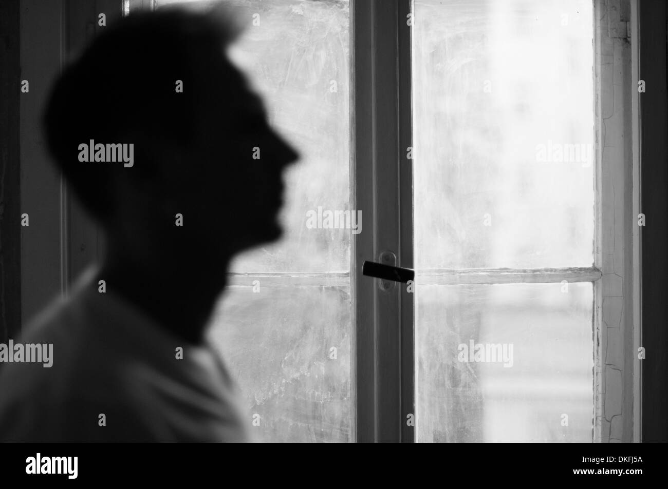 Man in front of window Stock Photo - Alamy