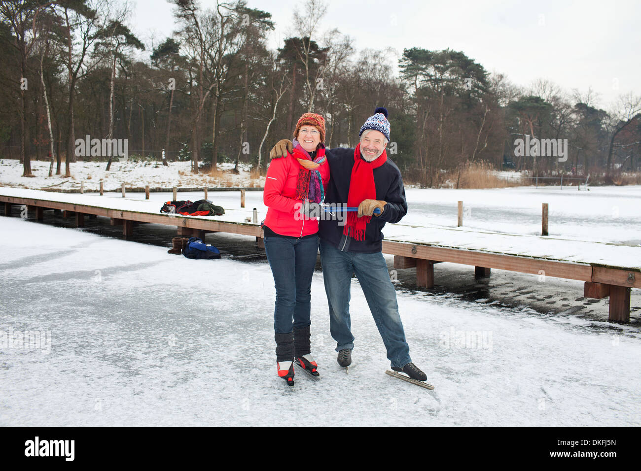 Couple ice skating, holding hands Stock Photo - Alamy
