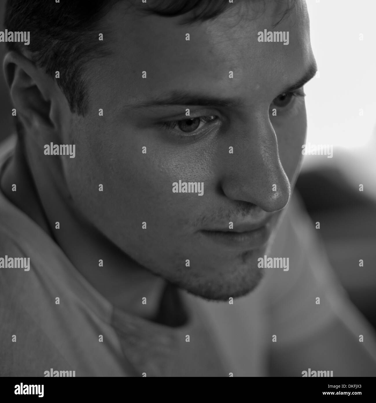 Thinking young man light Black and White Stock Photos & Images - Alamy