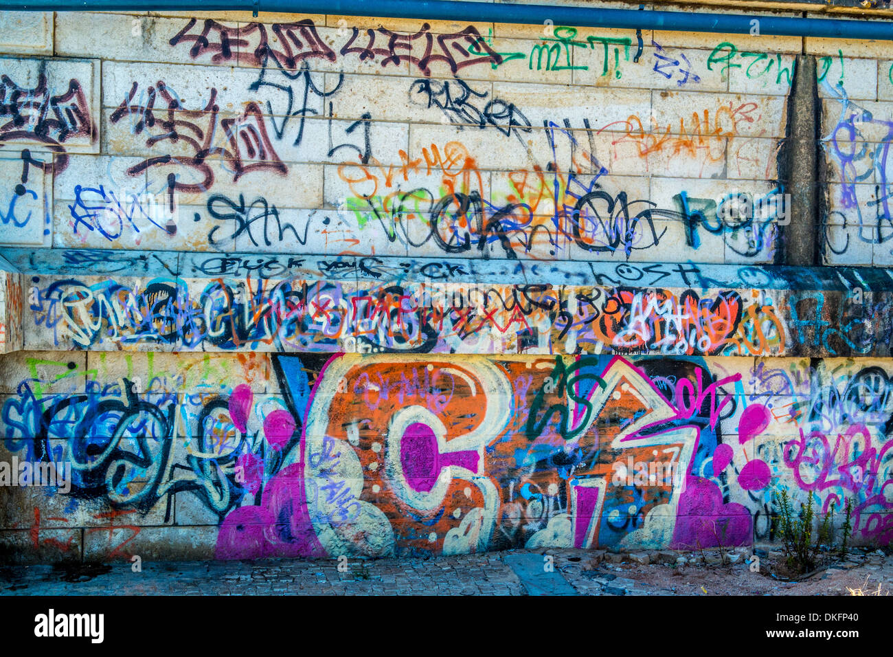 Graffito covered wall with multi-coloured paints Stock Photo - Alamy