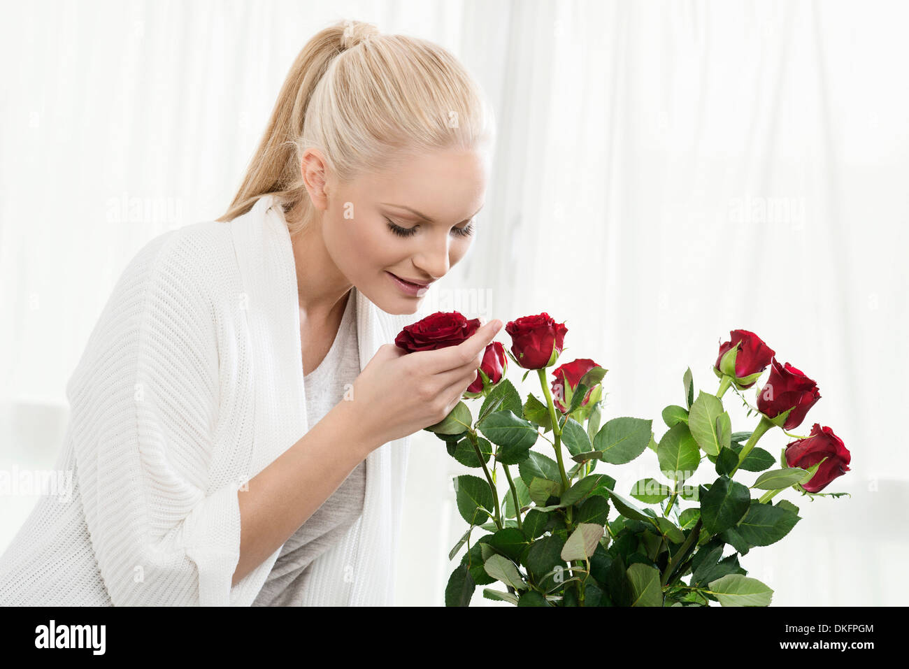 Woman smelling roses hi-res stock photography and images - Alamy