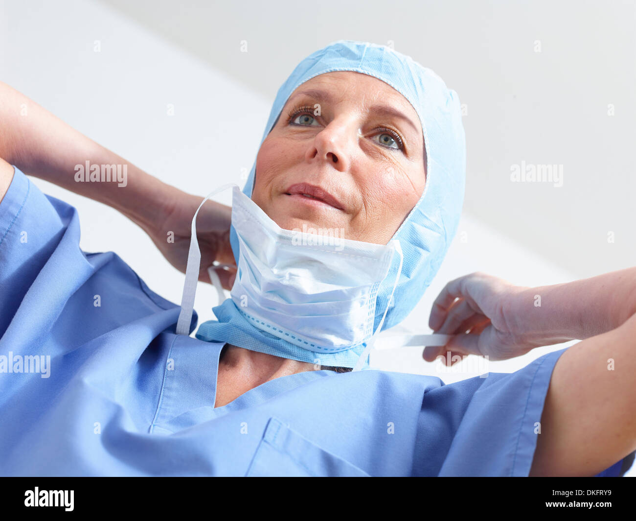 Woman putting on medical mask hi-res stock photography and images - Alamy