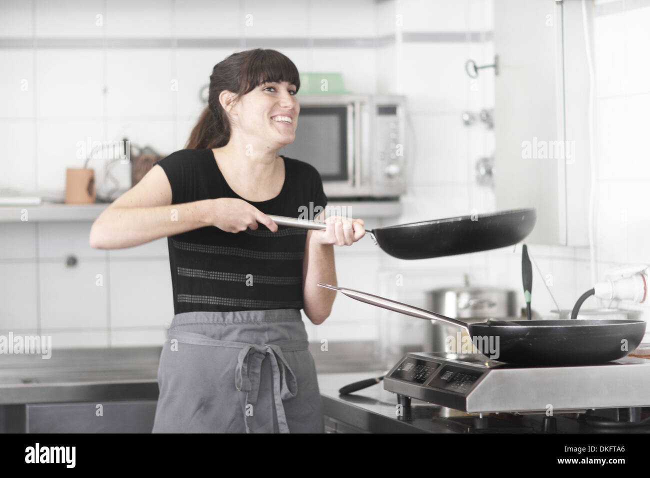 Woman chef holding frying pan hi-res stock photography and images - Alamy