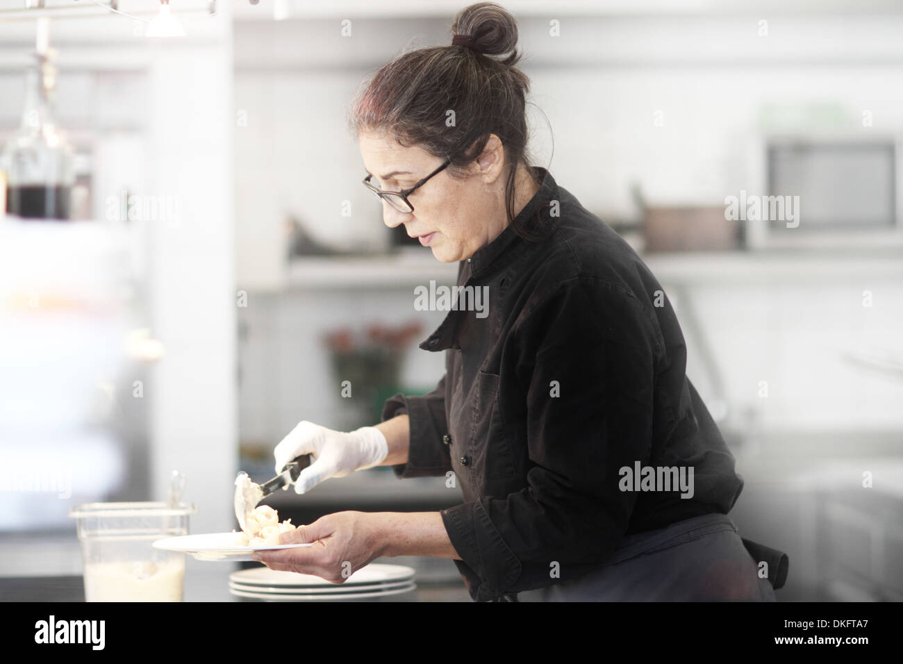 Professional cook serving meal hi-res stock photography and images - Alamy