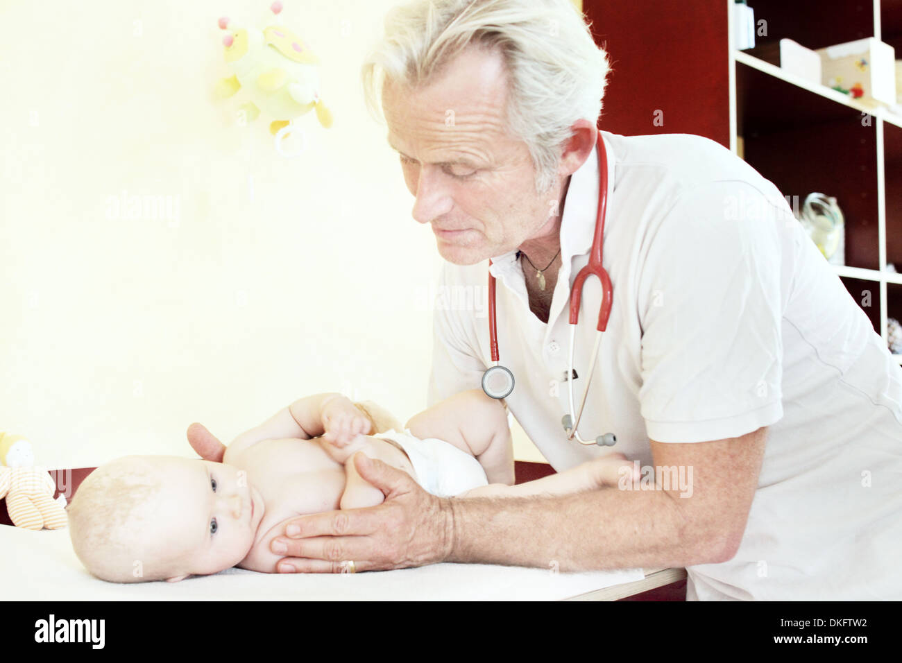 Paediatrician examining baby girl Stock Photo - Alamy