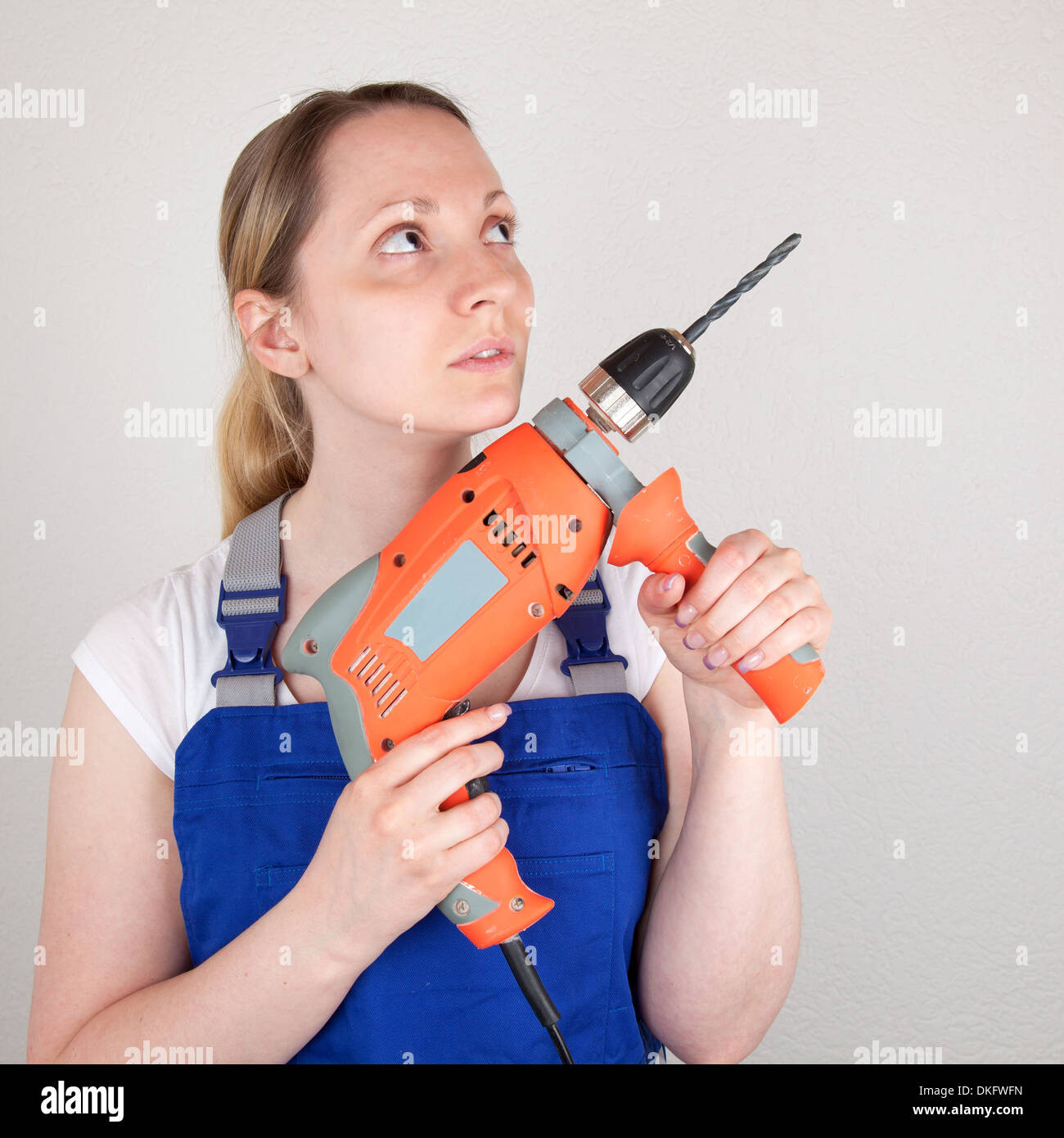 Woman holding power tool drill hi-res stock photography and images - Alamy