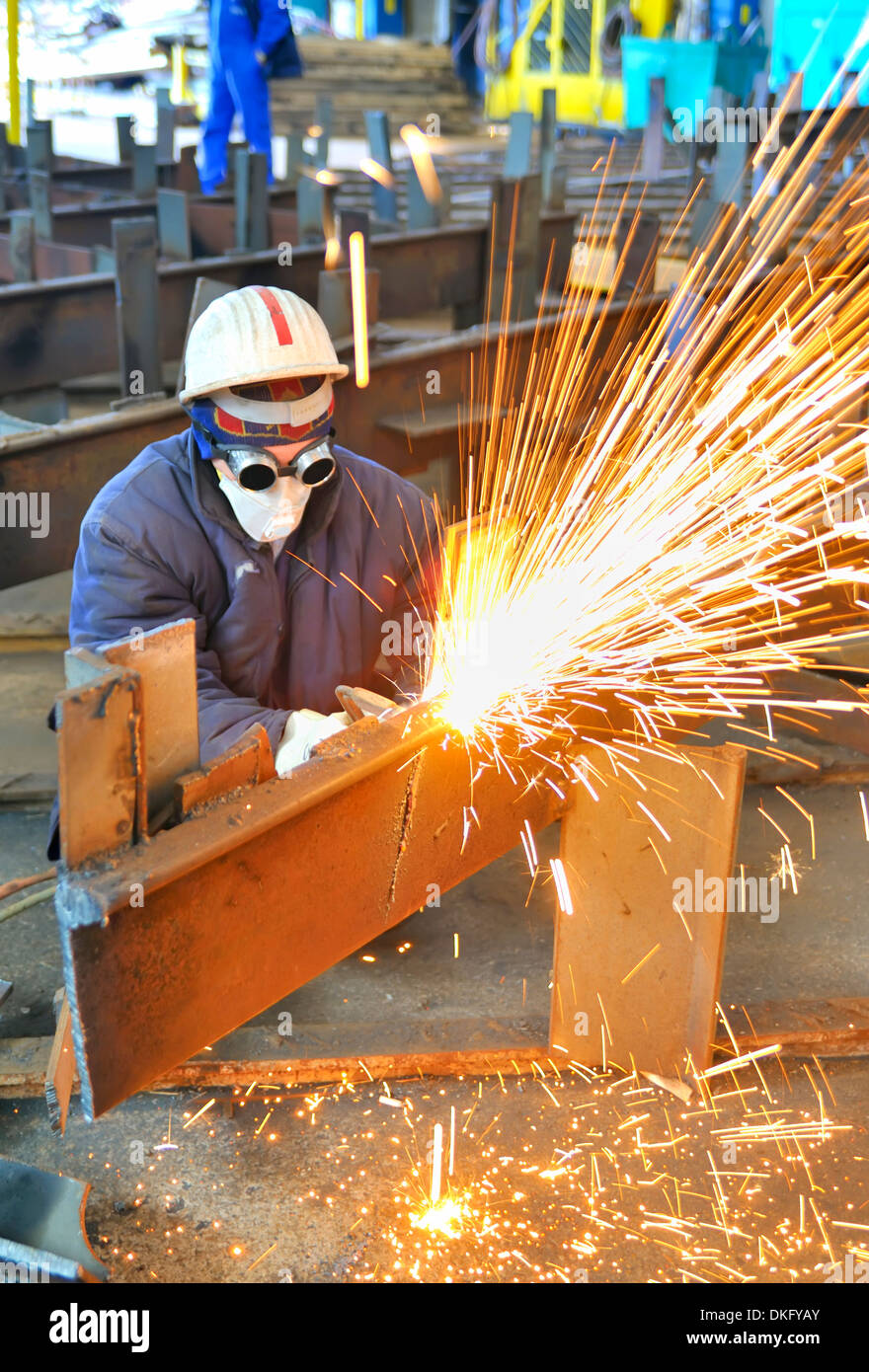 worker using torch cutter to cut through metal in factory Stock Photo ...
