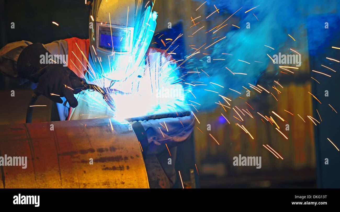 worker with protective mask welding metal and sparks Stock Photo - Alamy