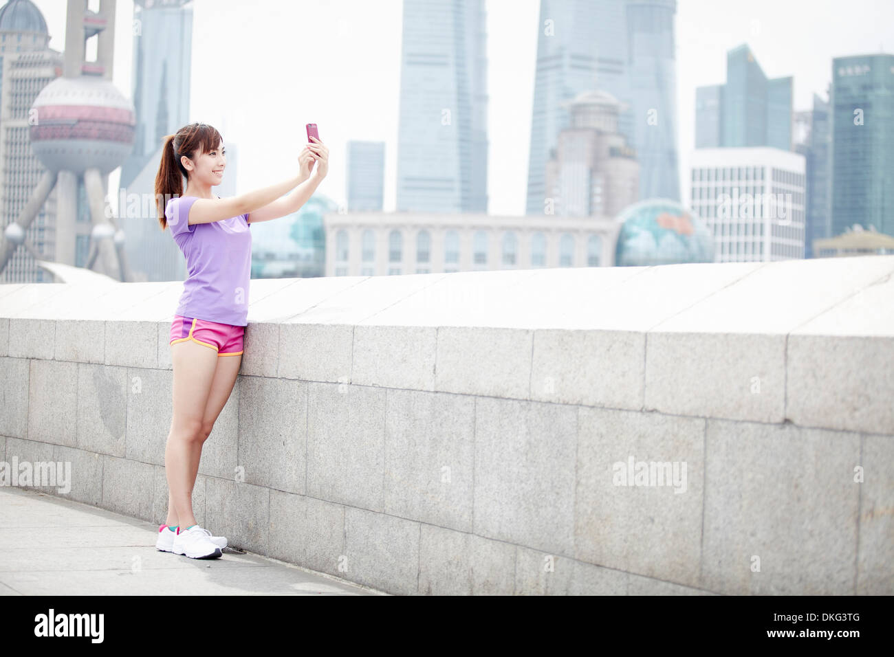 Young woman taking photograph in shanghai hi-res stock photography and ...