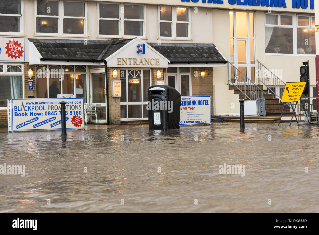 Residents from a seafront hotel try to stay dry from the flooded ...